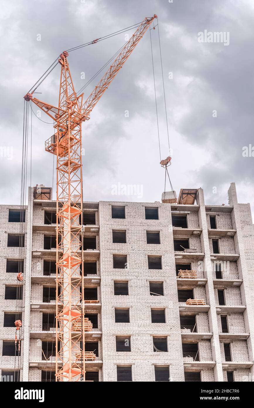 Powerful crane and construction of new apartments Stock Photo - Alamy