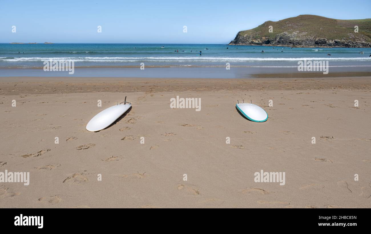 Shot of surf boards on a beach in the background of a wavy sea Stock ...