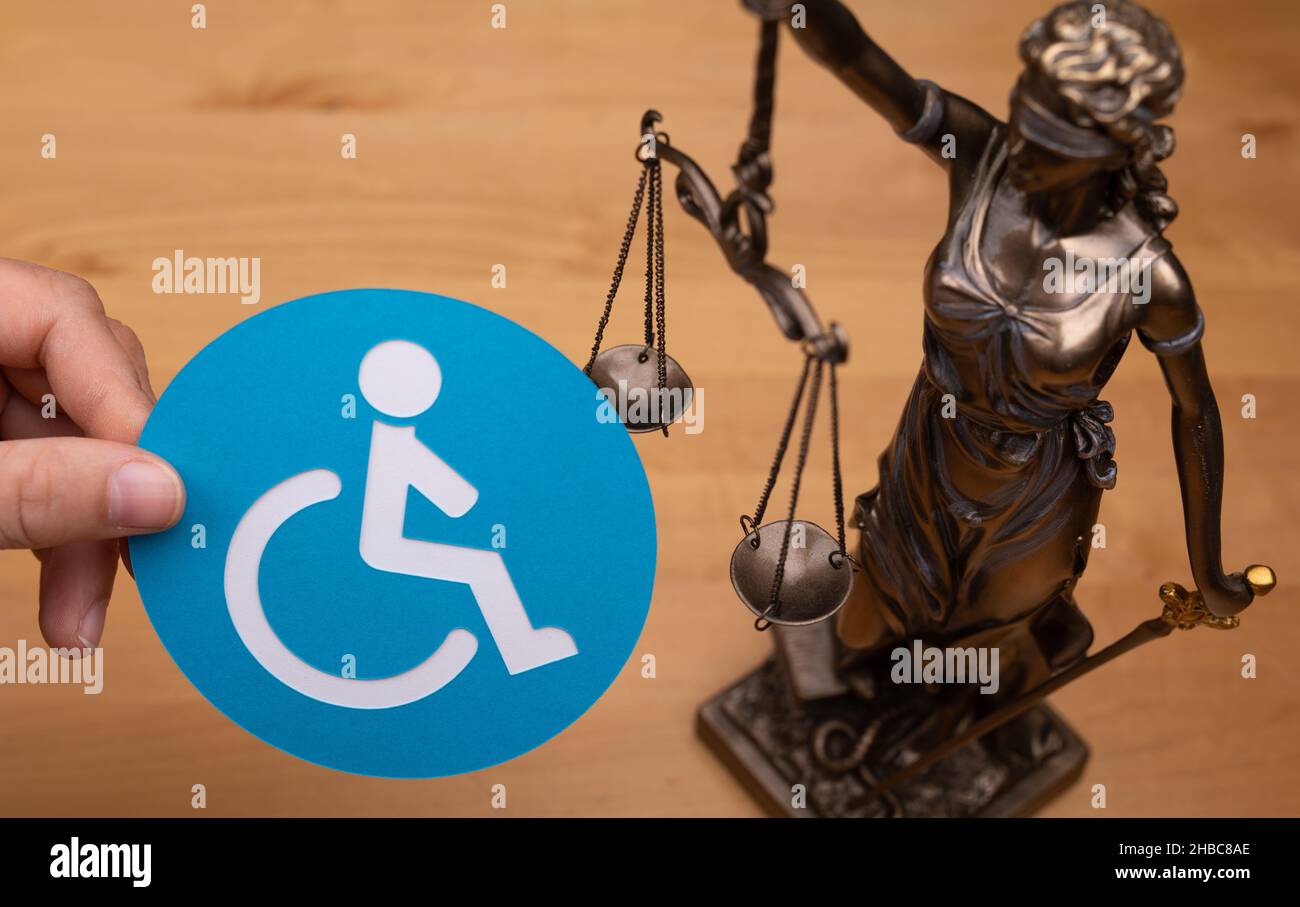 Person holding the disability sign with the sculpture of Themis the ...