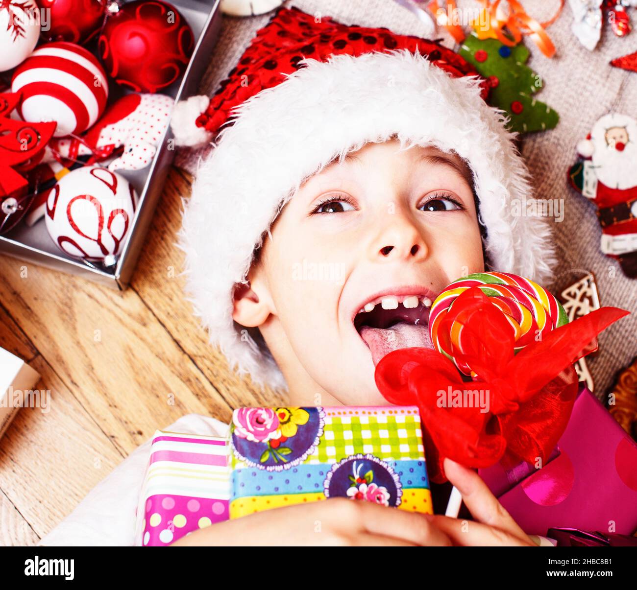 little cute boy with Christmas gifts at home. close up emotional happy ...