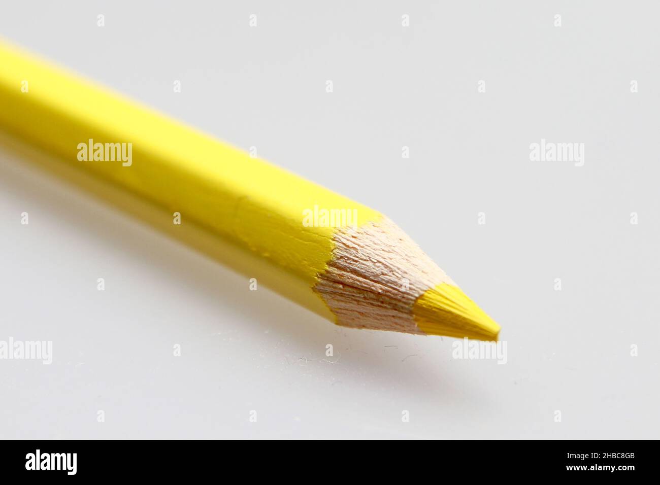 Close-up shot of a yellow colored pencil for drawing isolated on a ...