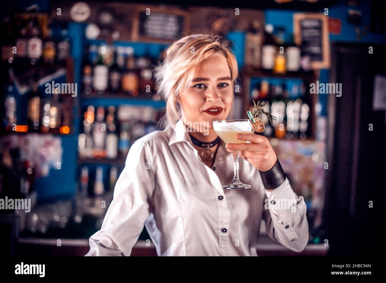 Experienced girl bartending surprises with its skill bar visitors in pub Stock Photo - Alamy