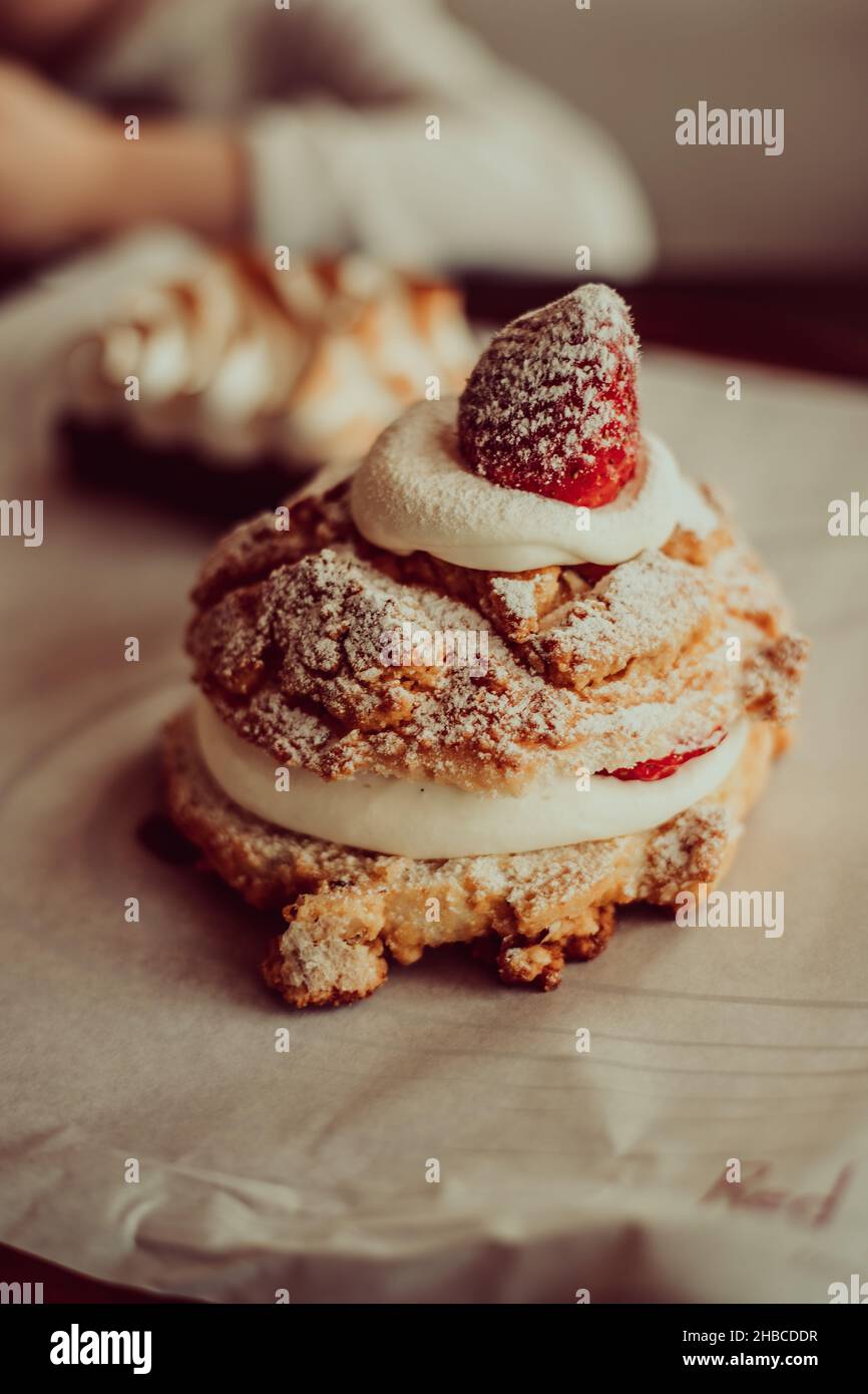 Vertical shot of a delicious homemade choux pastry with soft cream and ...