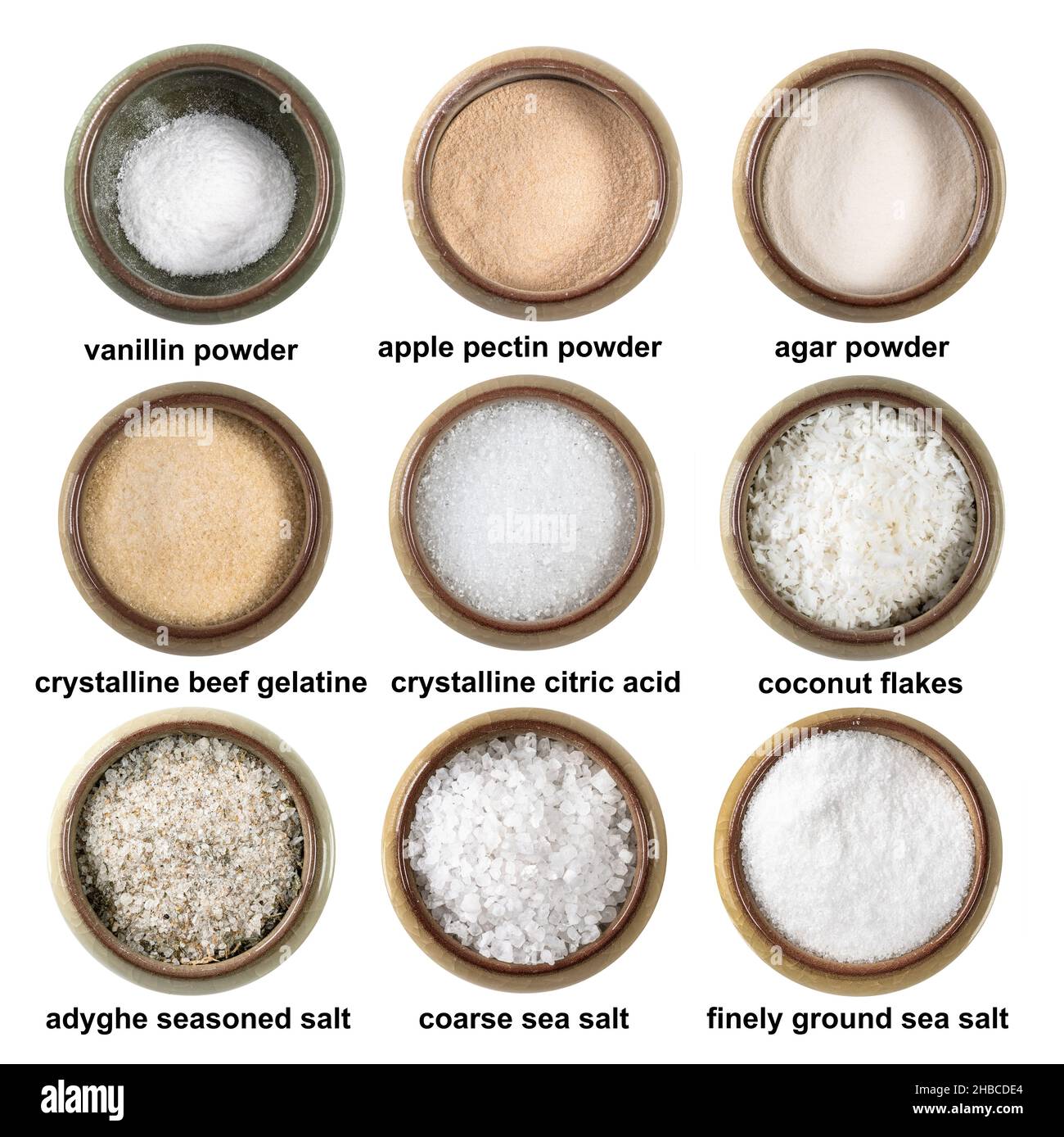 set of various cooking ingredients in bowls with names cutout on white ...