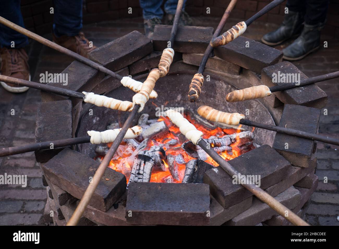A High Angle View Of Bonfire On Barbecue Grill With Bread On Sticks ...