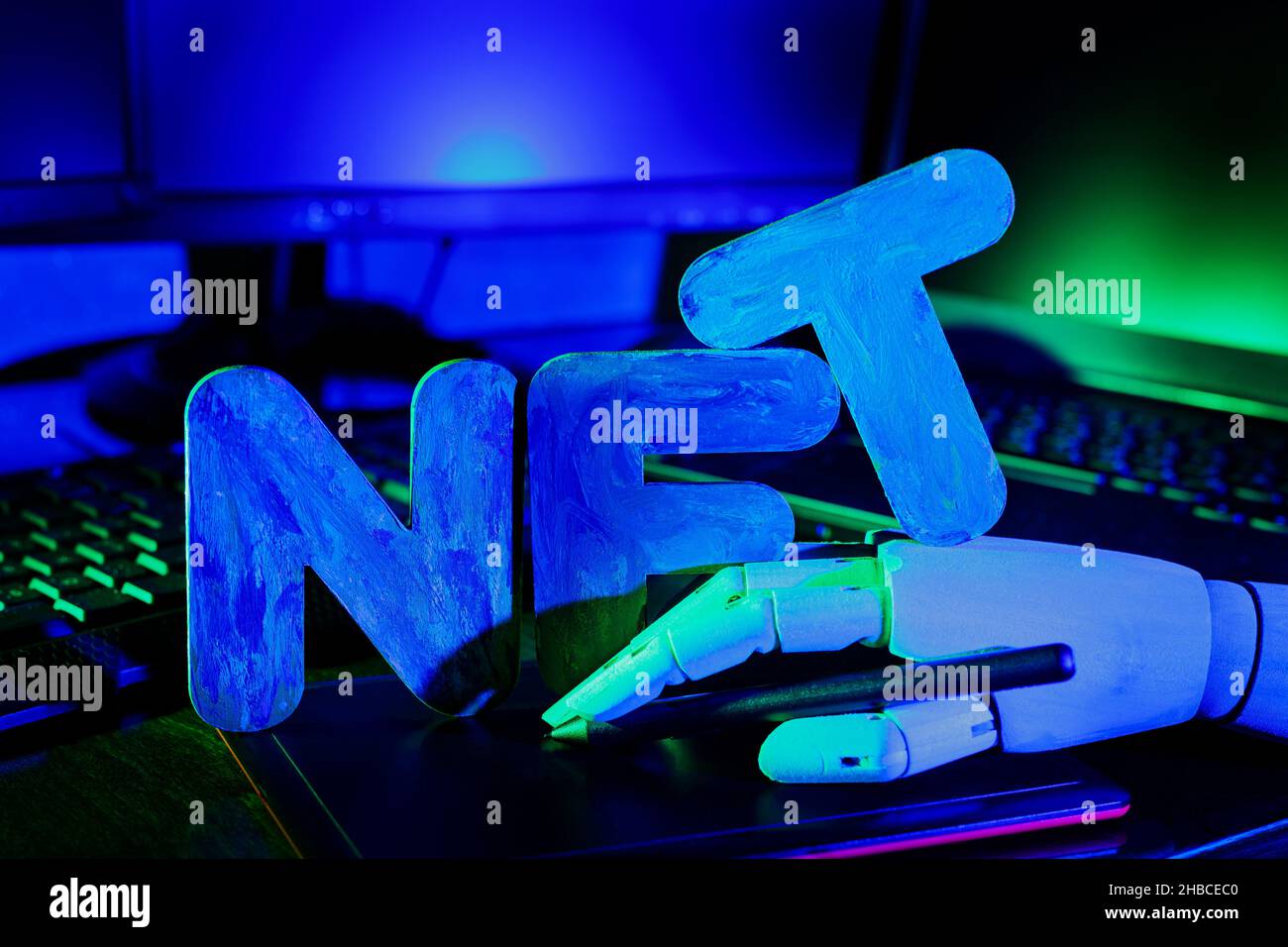 NFT Non-Fungible token. Artificial hand creates crypto art using a ...