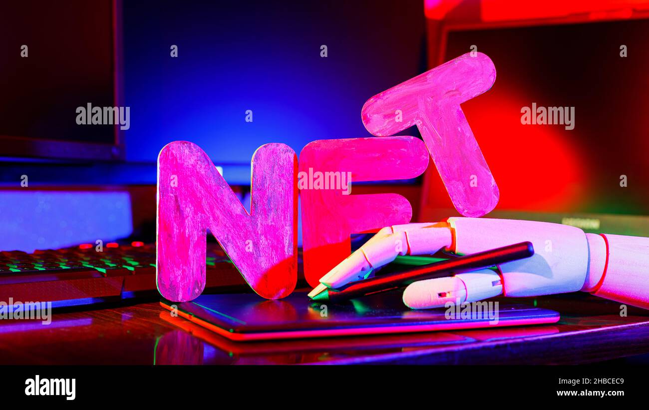 NFT Non-Fungible token. Artificial hand creates crypto art using a ...