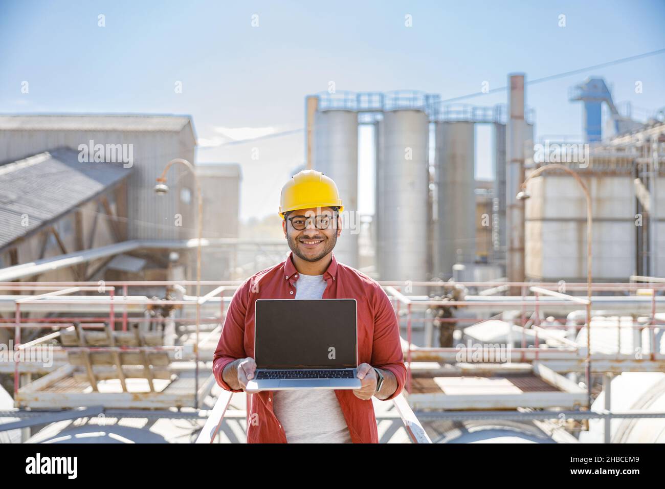 Experienced engineer with hard hat in factory Stock Photo - Alamy