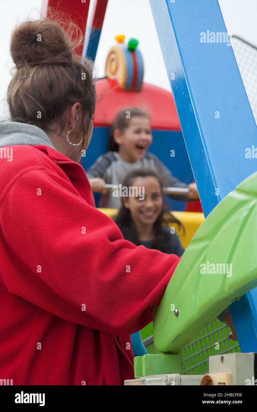 Weymouth Dorset UK 07 30 2018 Two girls enjoying a fair ride in the UK ...