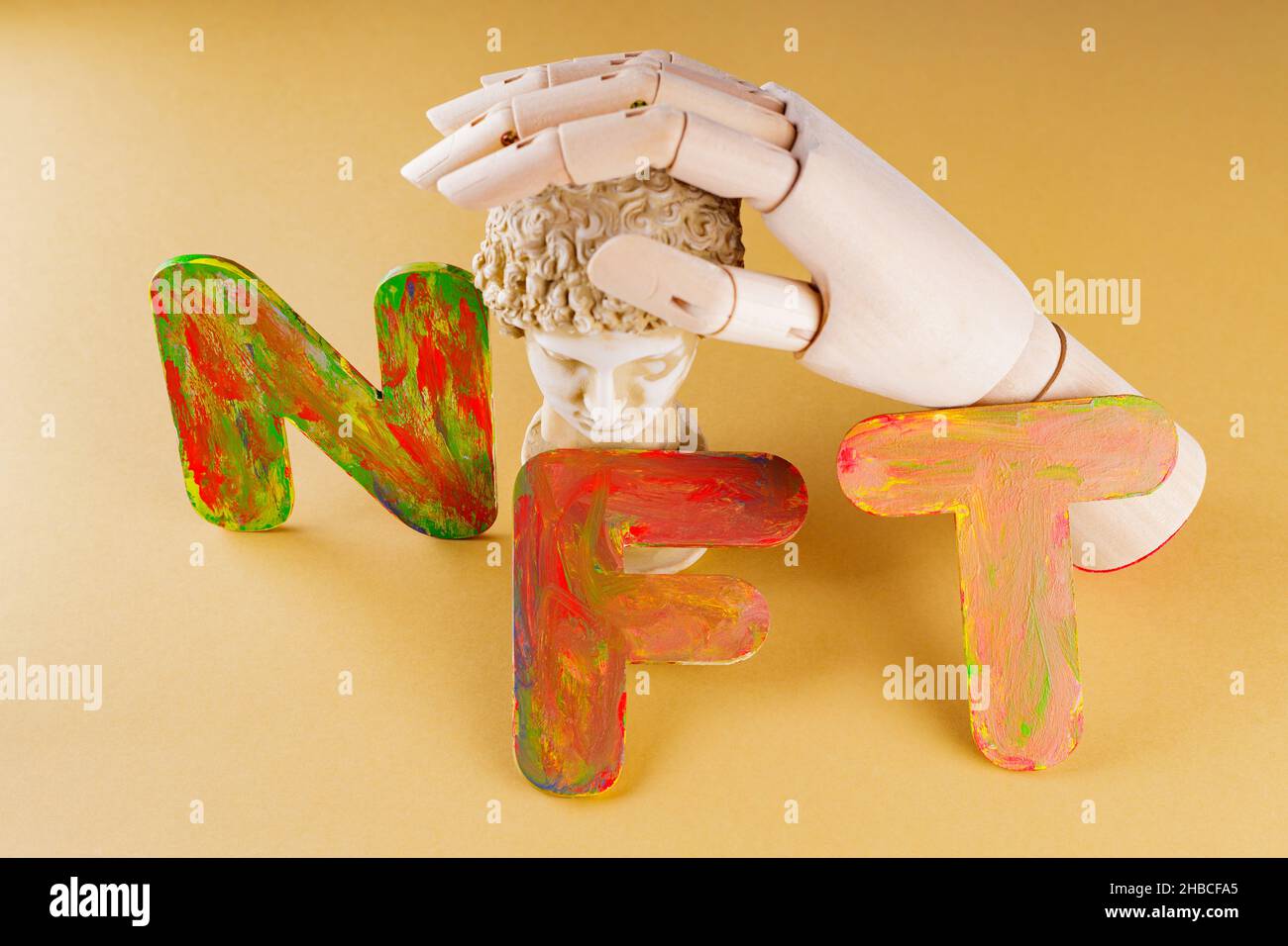 NFT (Non-Fungible token). Artificial fingers hug the plaster head of ...