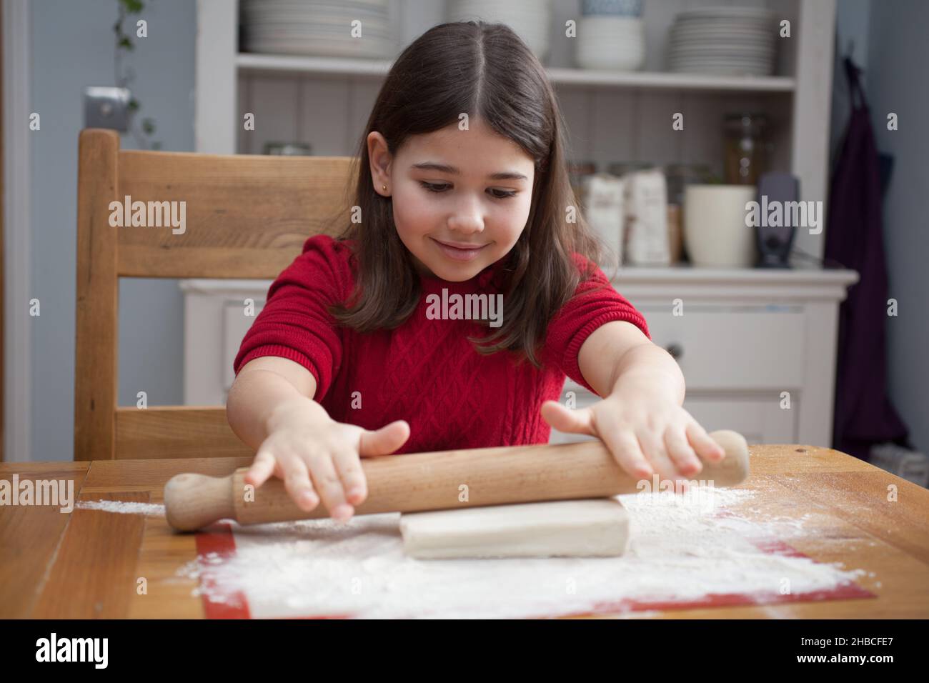 A girl rolling pastry Stock Photo - Alamy