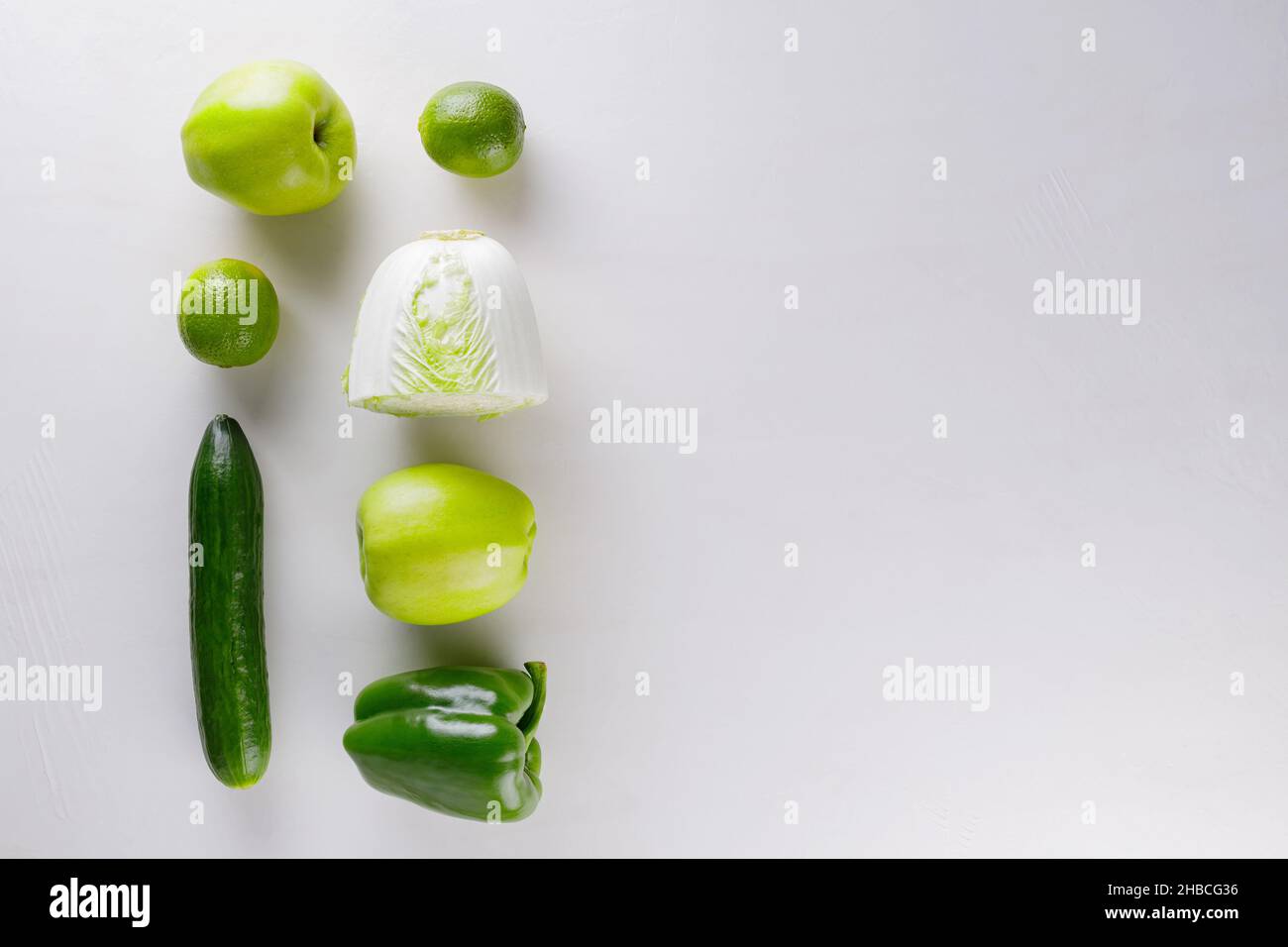 Different green vegetables and fruits on a white background. Healthy ...