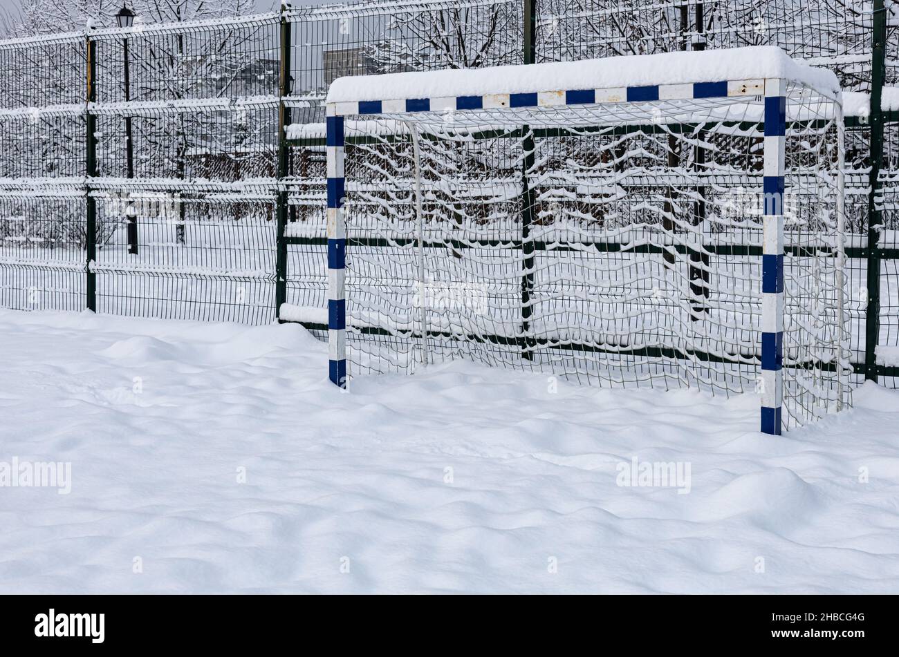 football goal covered with snow on the background of a snow-covered ...