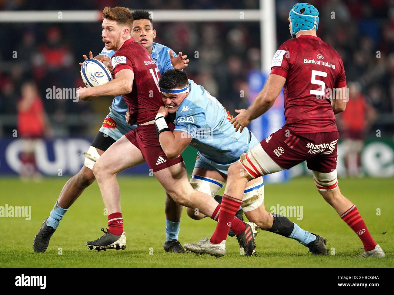 Munster's Ben Healy is tackled by Castres' Simon Meka and Theo Hannoyer ...