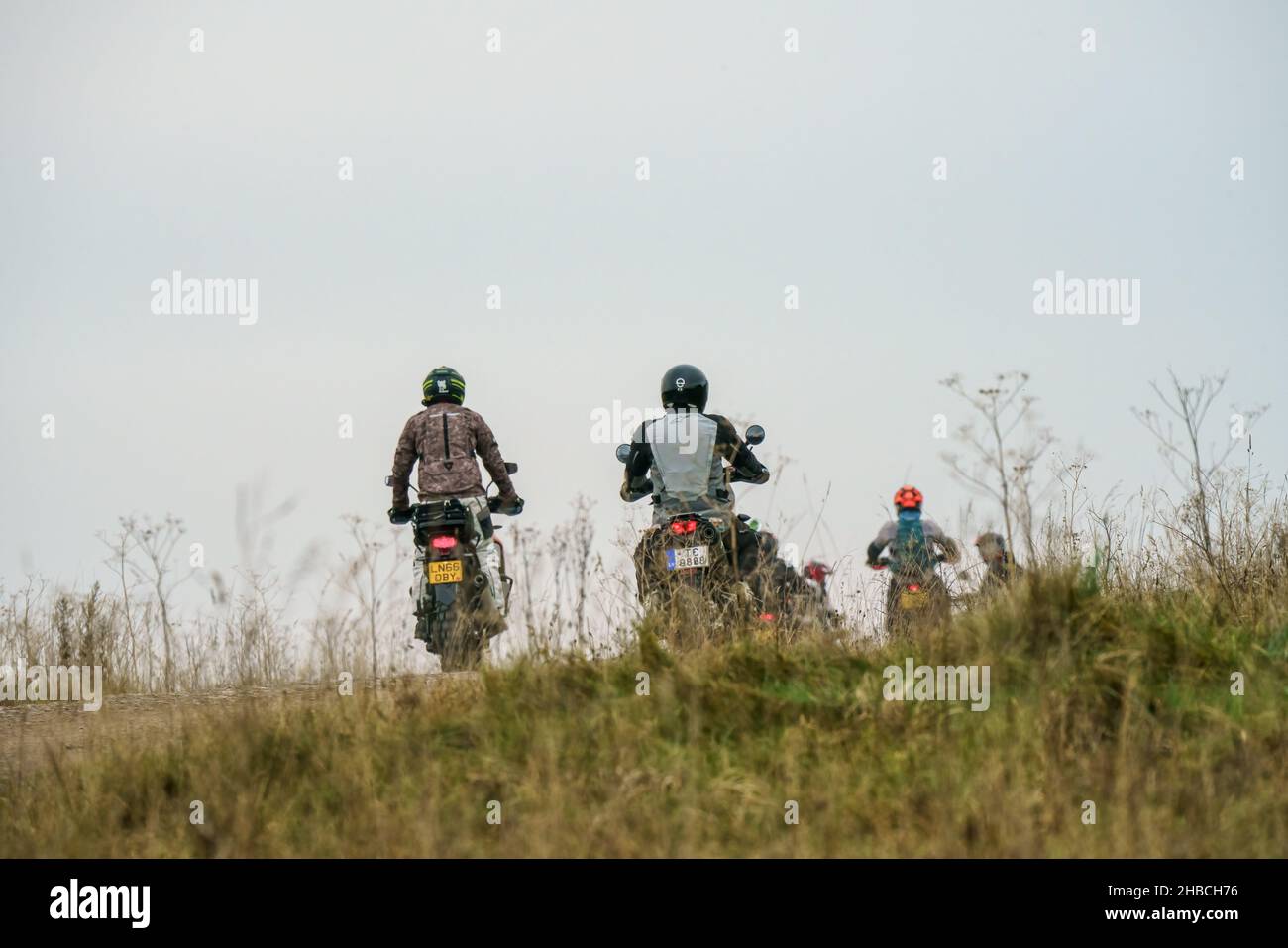 a group of motor cyclists (bikers) riding their off-road motorbikes ...