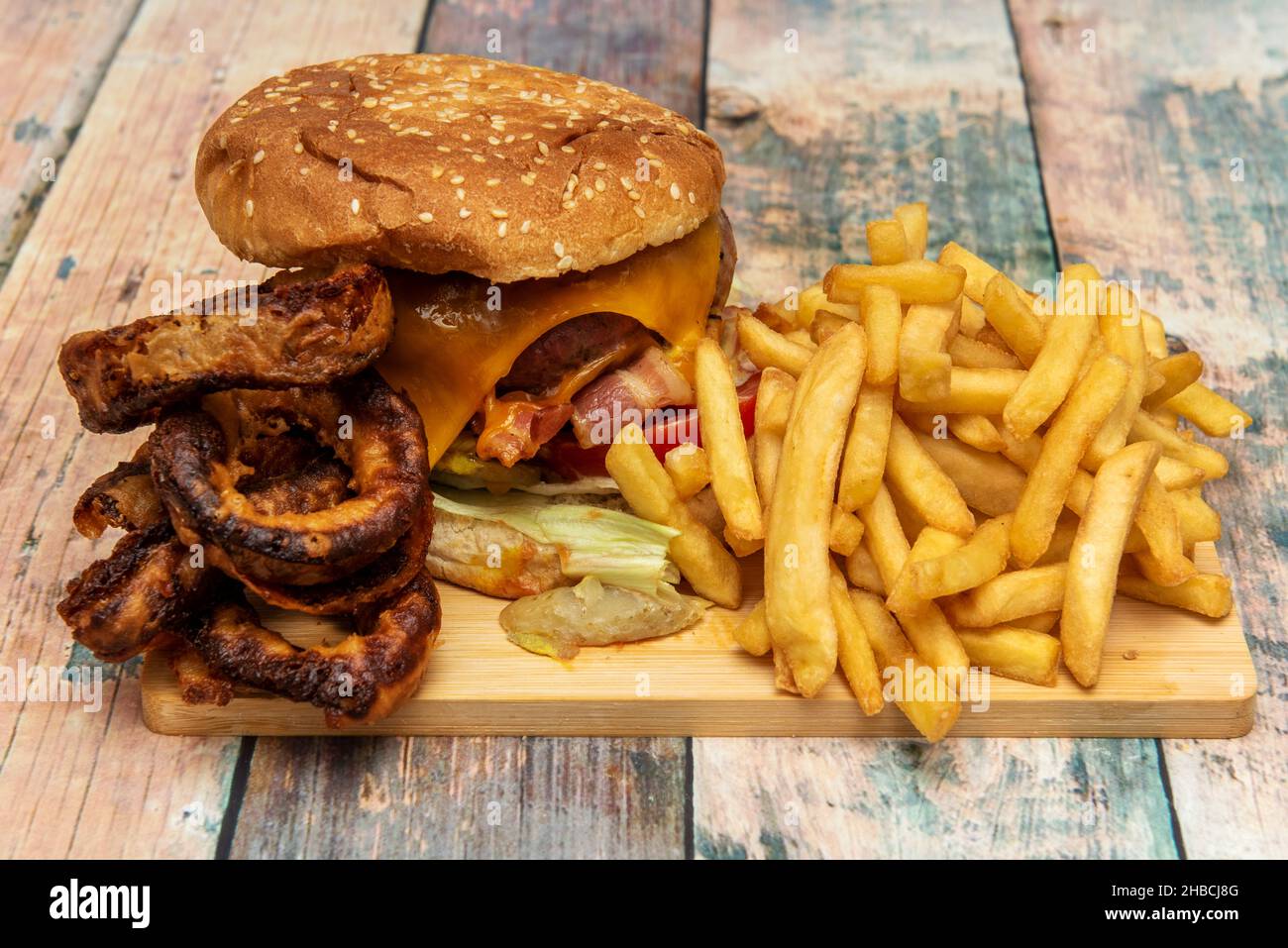 Beef burger menu with crispy onion rings, melted cheddar cheese, side ...