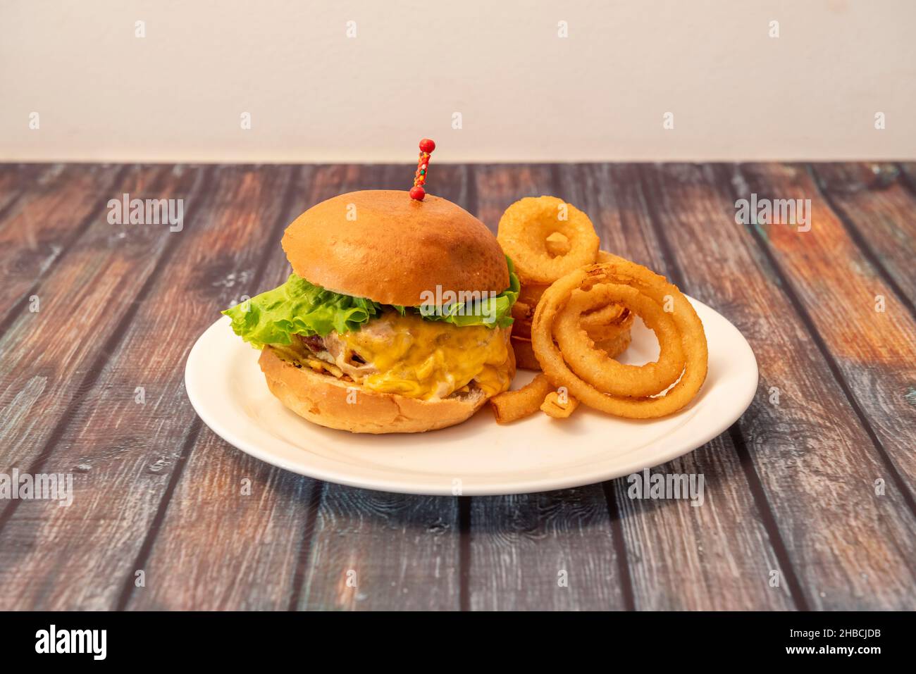 Beef burger with brioche bread, cream sauce, lettuce and crispy fried ...
