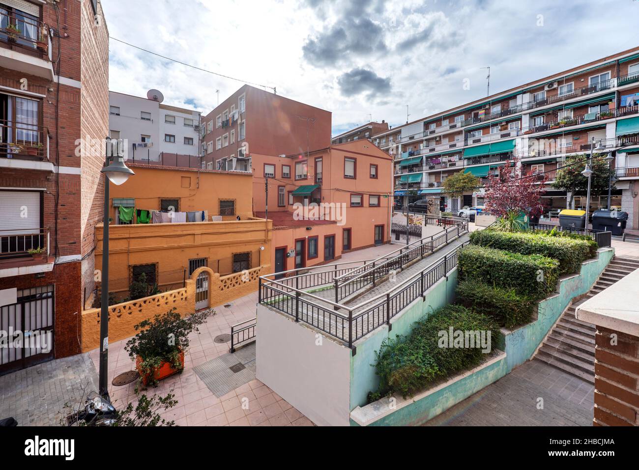 Buildings of various sizes and constructions with stairs going down to ...