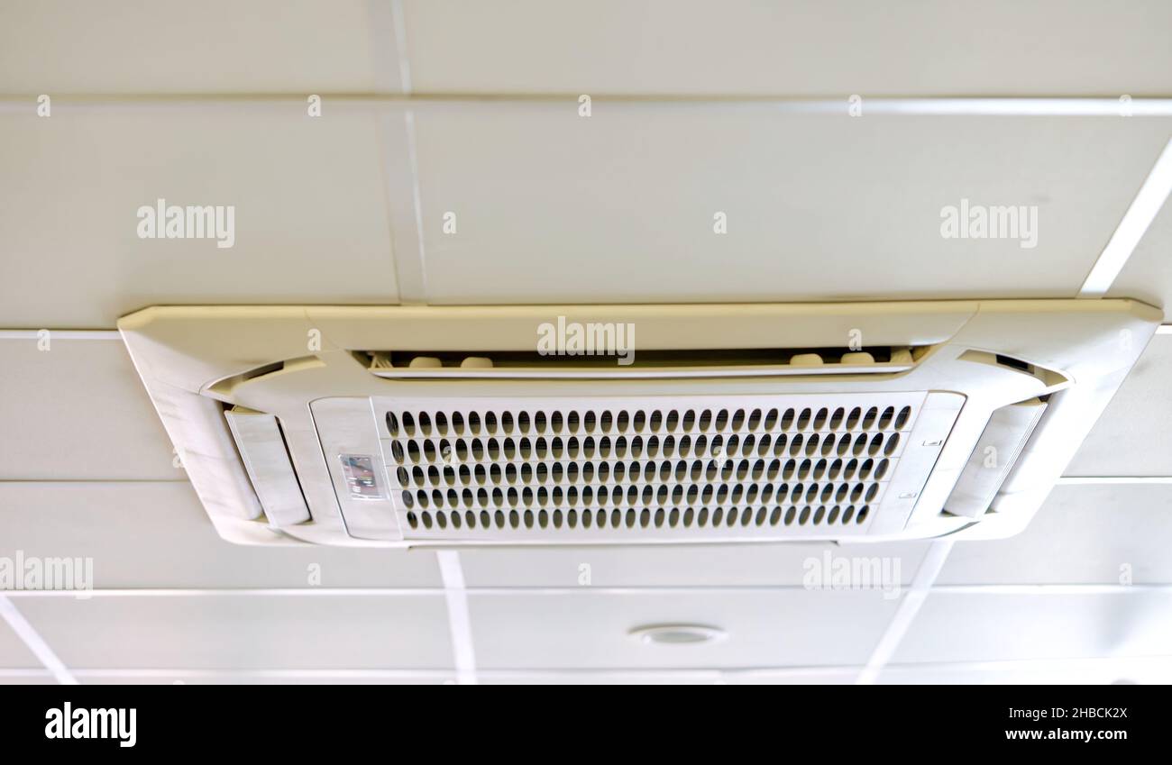 cassette type air conditioner mounted on ceiling wall. Air duct on ...
