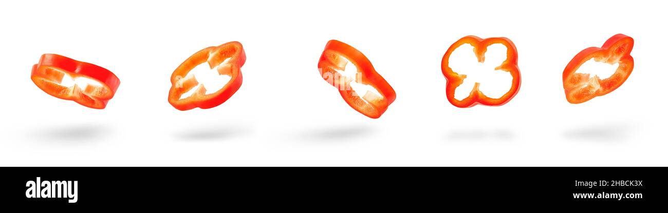 Set of slices of red pepper drops on a white background. Paprika flying ...