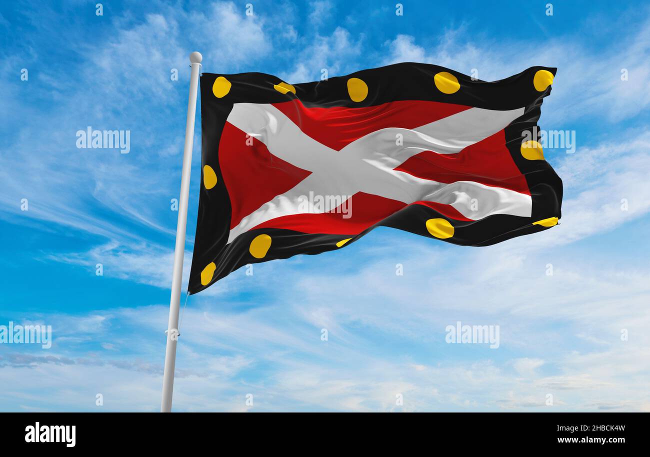 flag of Hampton Poyle village at cloudy sky background on sunset ...