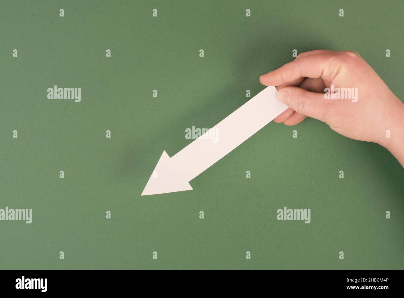 Holding an arrow in the hand, showing down, negative evaluation ...