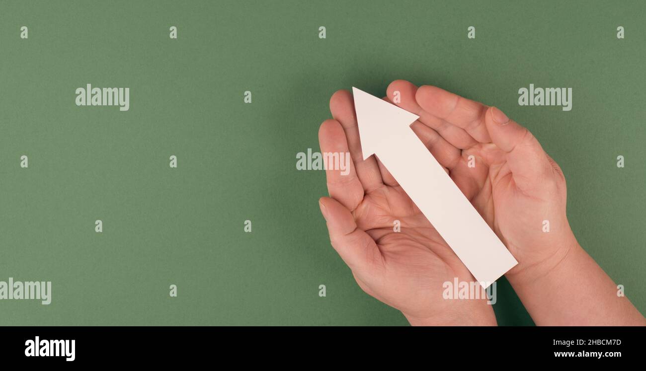 Holding an arrow in the hand, symbol for growth, success and ...