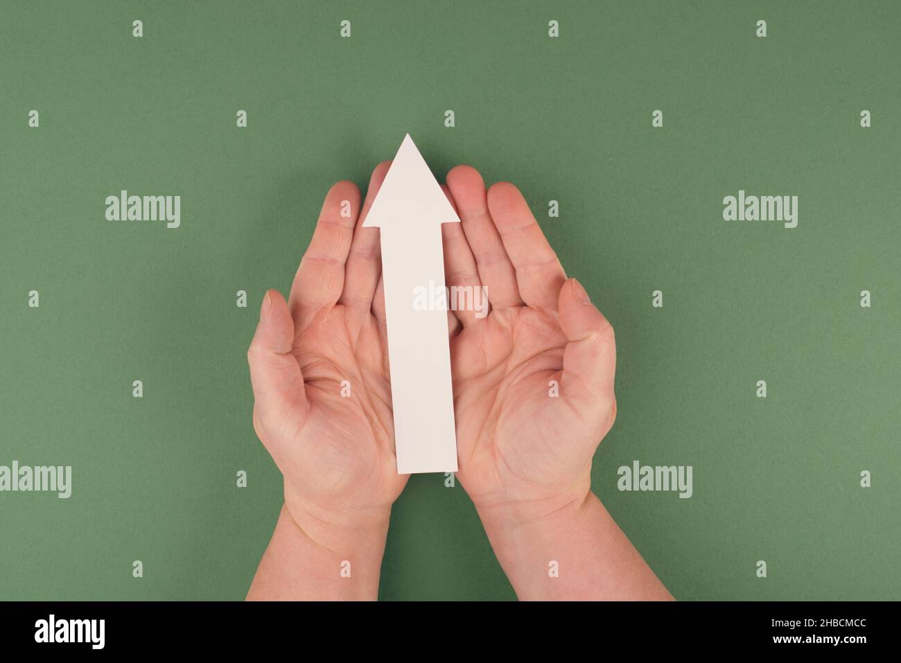 Holding an arrow in the hand, symbol for growth, success and ...