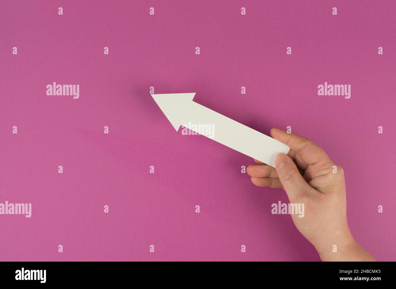 Holding an arrow in the hand, symbol for growth, success and ...