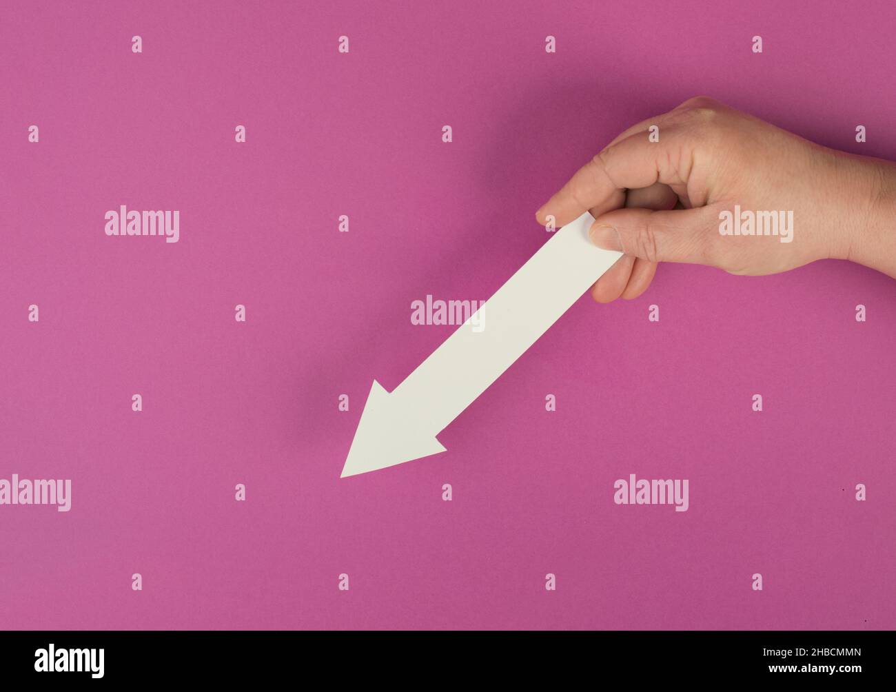 Holding an arrow in the hand, showing down, negative evaluation ...