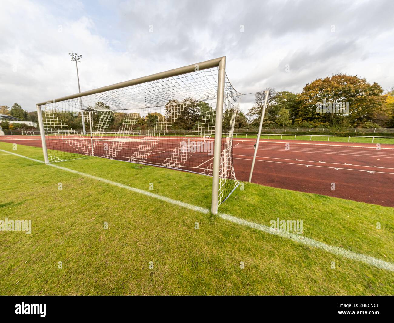 Empty football goal in the field and running track in the stadium ...