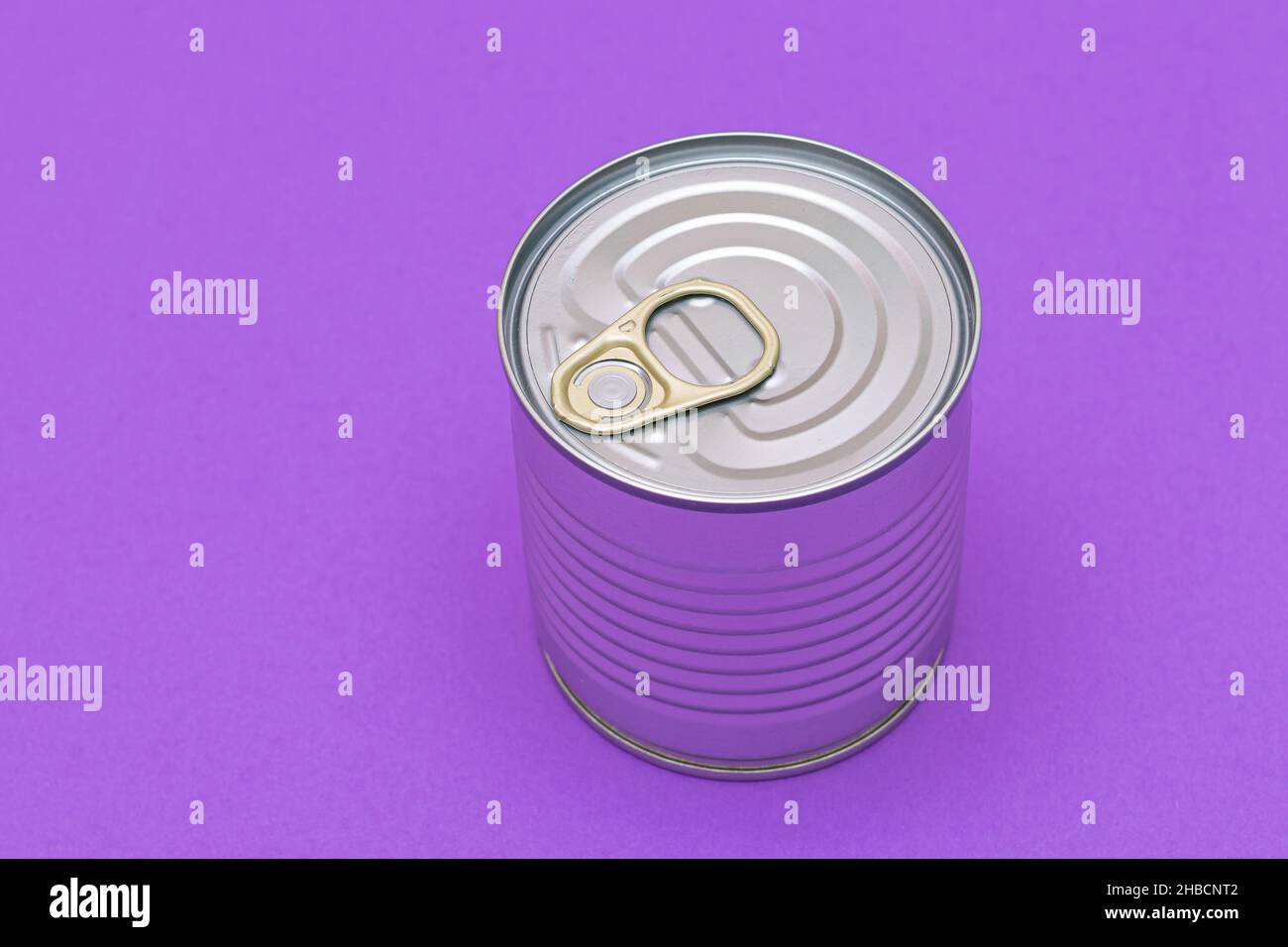 Unopened Tin Can with Blank Edge on Violet Background. Canned Food ...