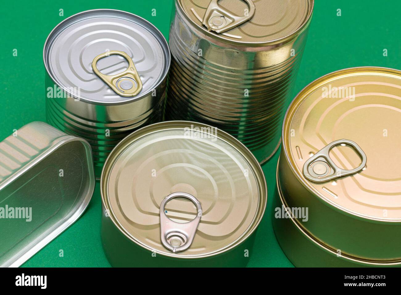 A Group of Stacked Tin Cans with Blank Edges on Green Background ...