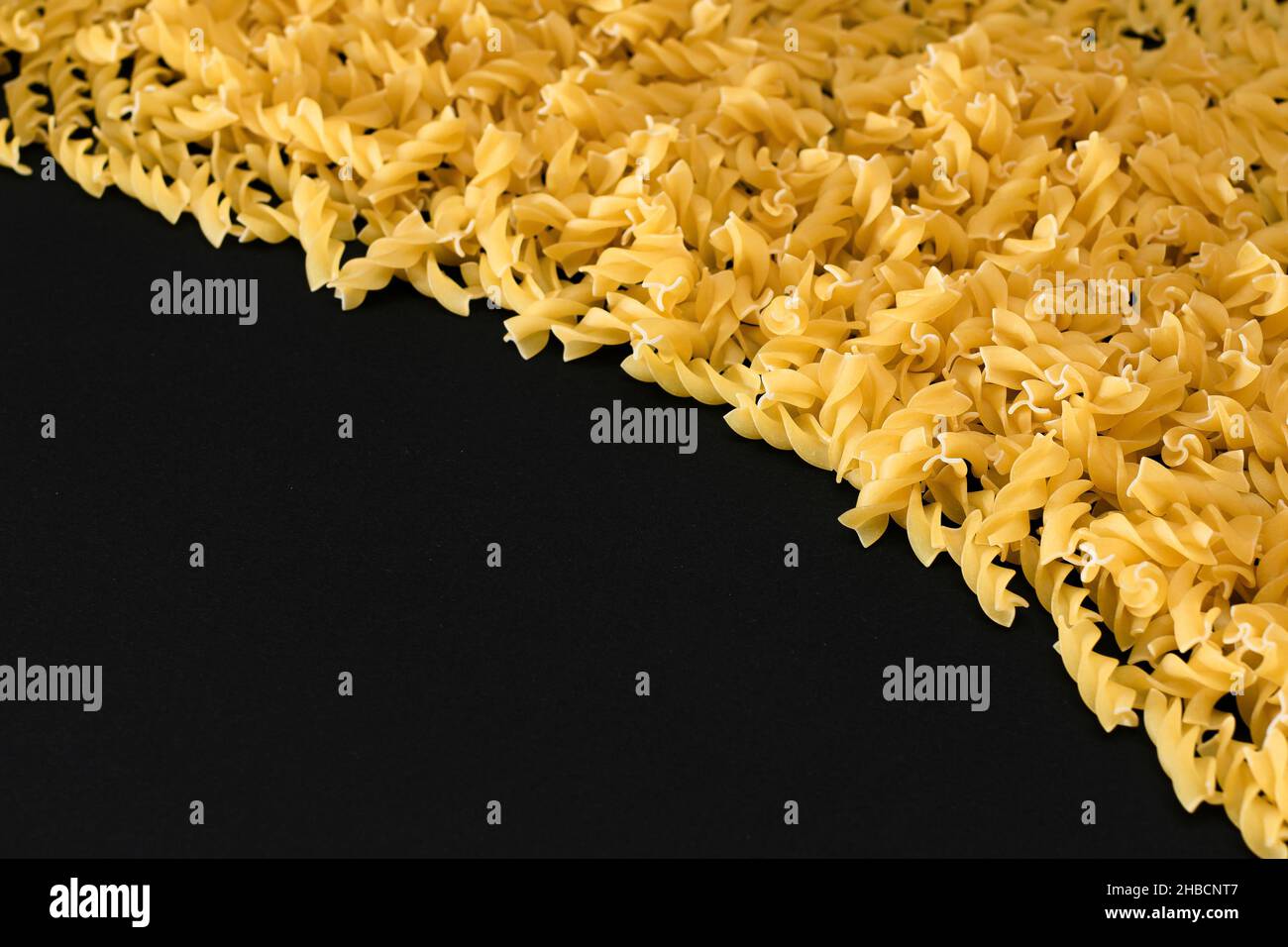 Uncooked Fusilli Pasta with Copy Space on Black Background. Raw and Dry ...