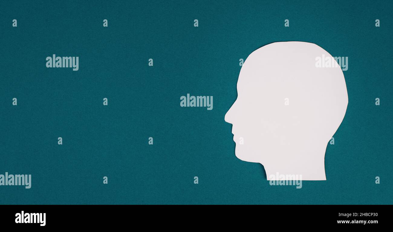 Face paper cut out, petrol colored background, copy space for text ...