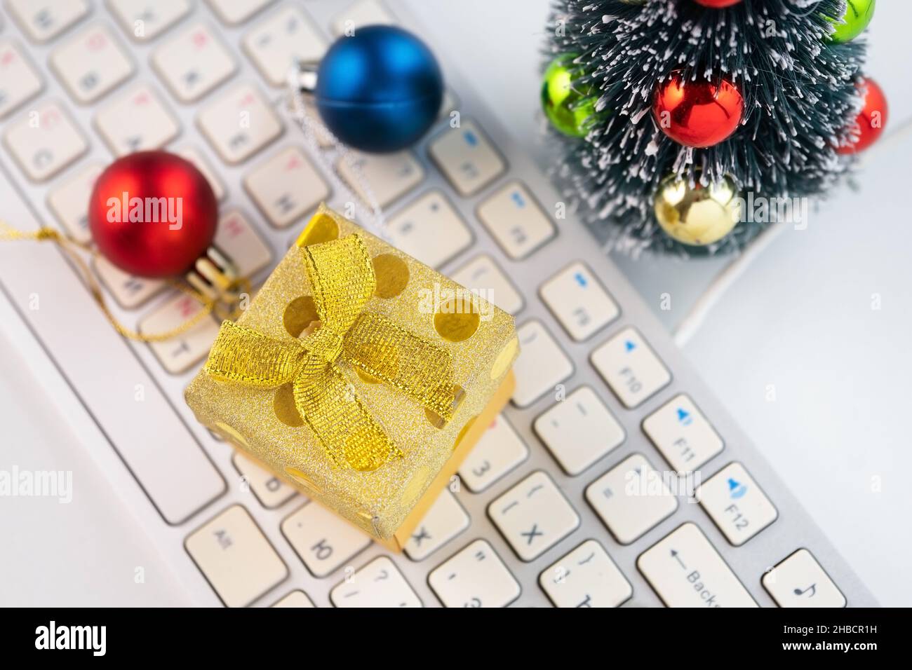 Gift box and Christmas balls on the computer keyboard Stock Photo - Alamy