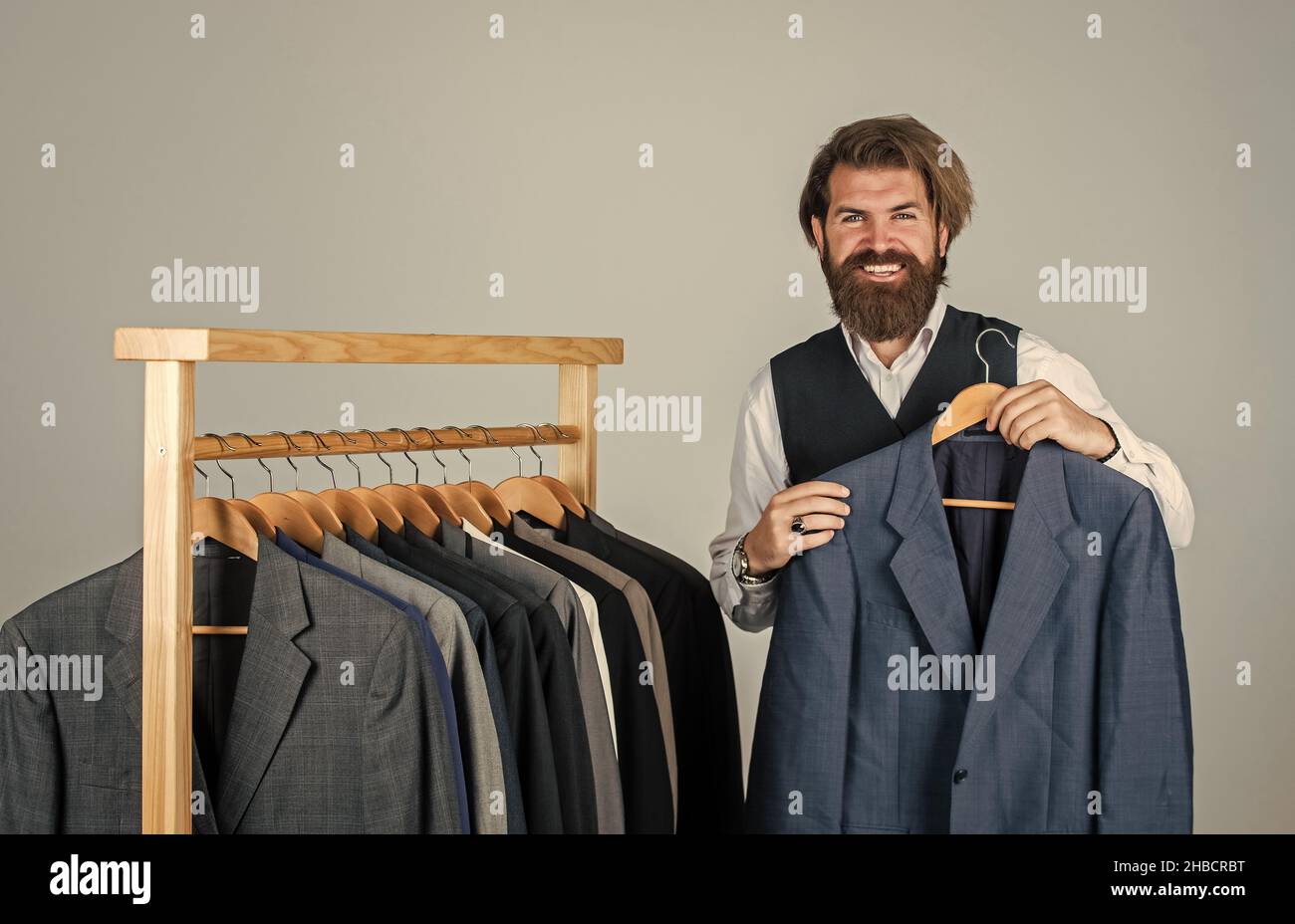 Bearded man collector vintage clothes showing formal suit, tweed jacket ...