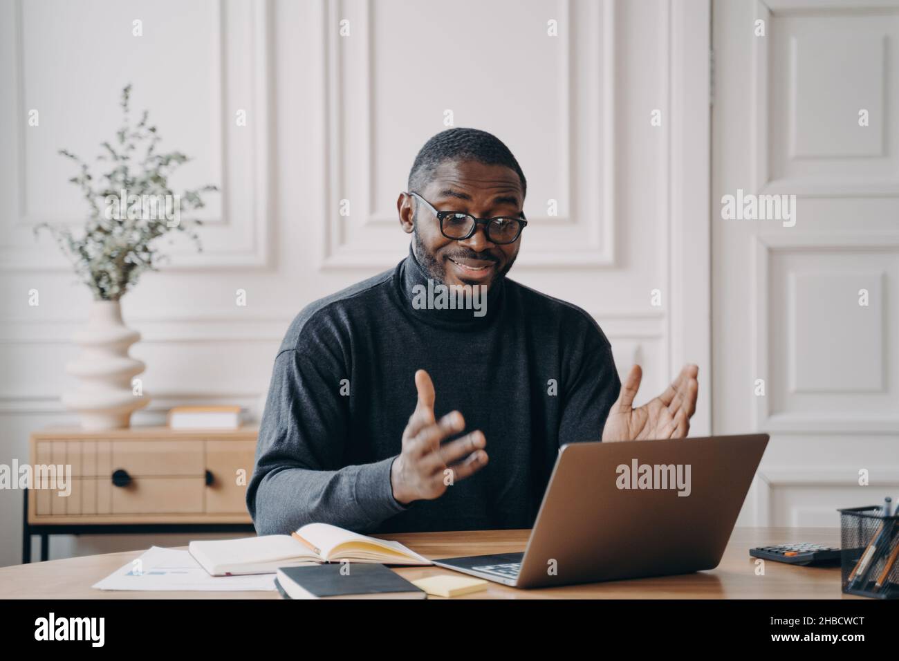 Young positive afro american man tutor talking with students during ...
