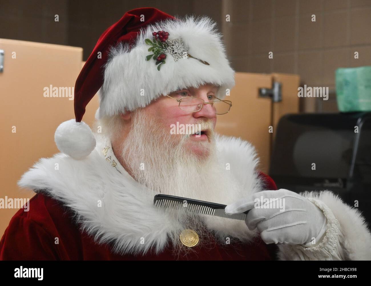Santa combs out his beard. A man that believes he is Santa Claus ...