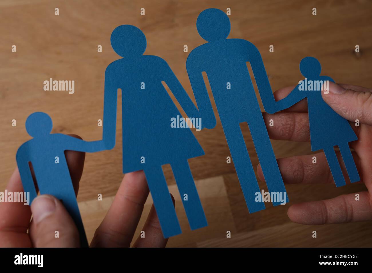 Woman holding paper figures hi-res stock photography and images - Alamy