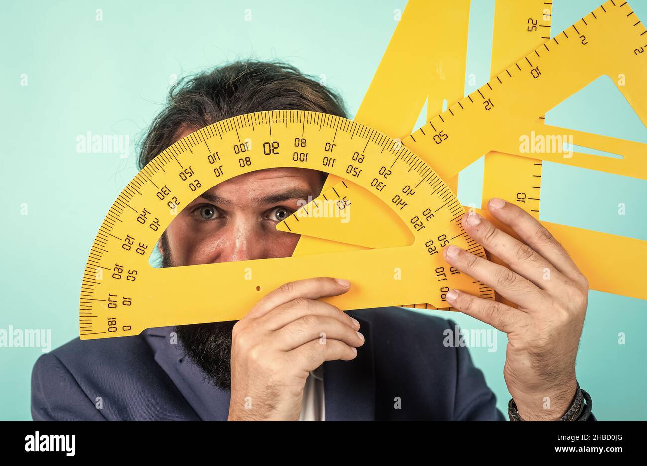 protractor and triangle tool in hand of math man teacher, education at ...