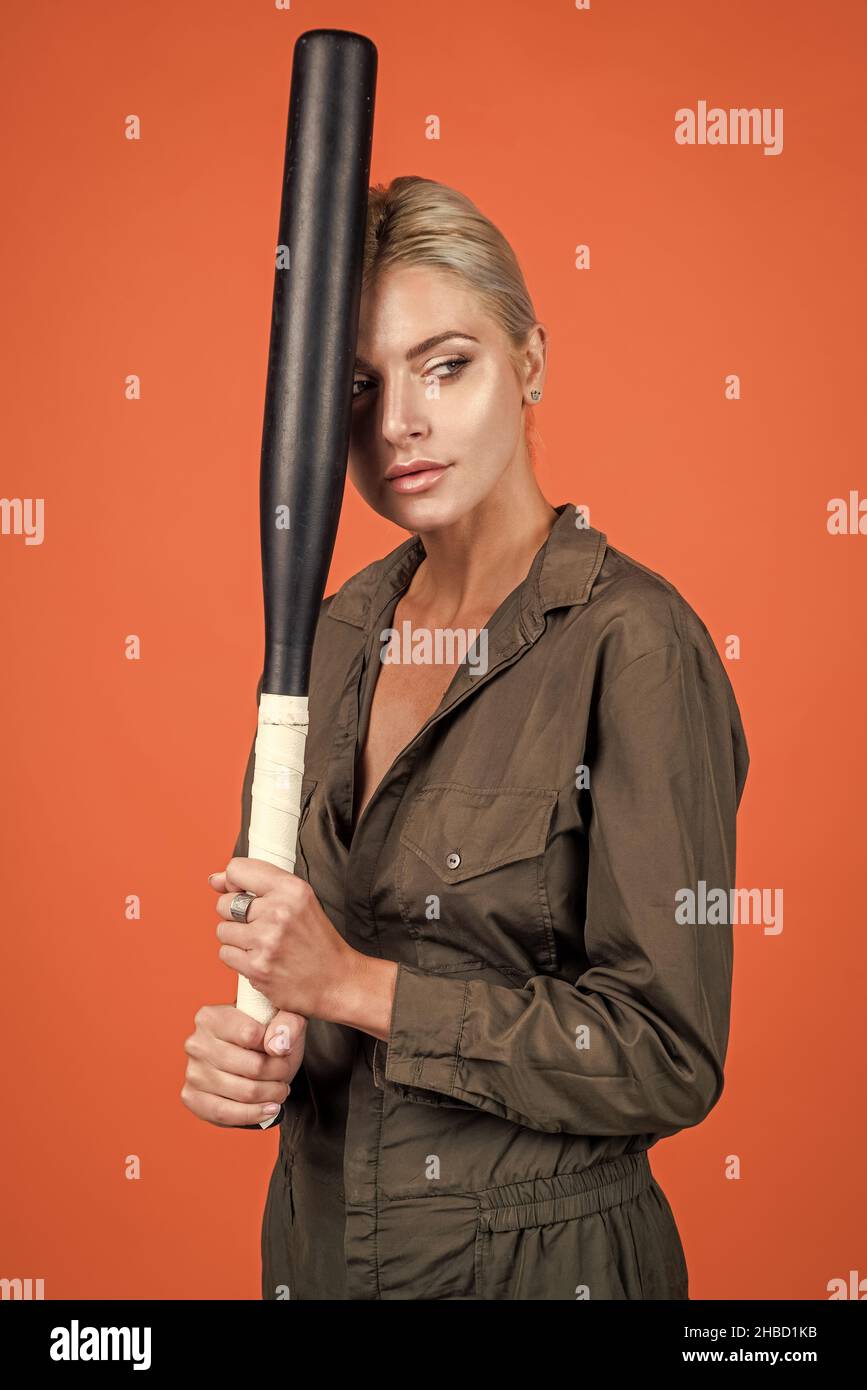 looking away. rounders game. woman in boilersuit with bat. female ...
