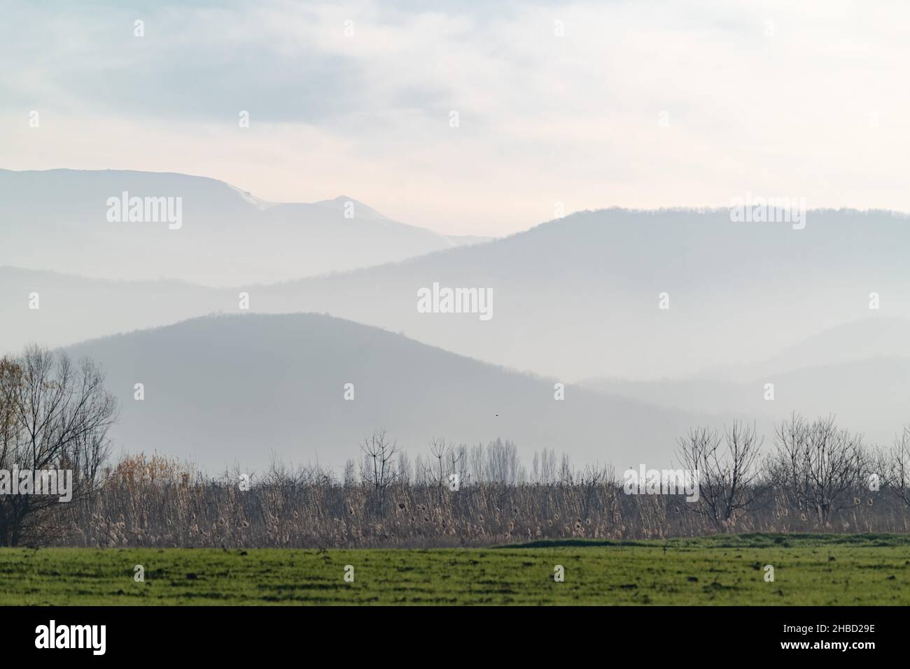 Silhouettes of mountains in the sunset haze Stock Photo - Alamy