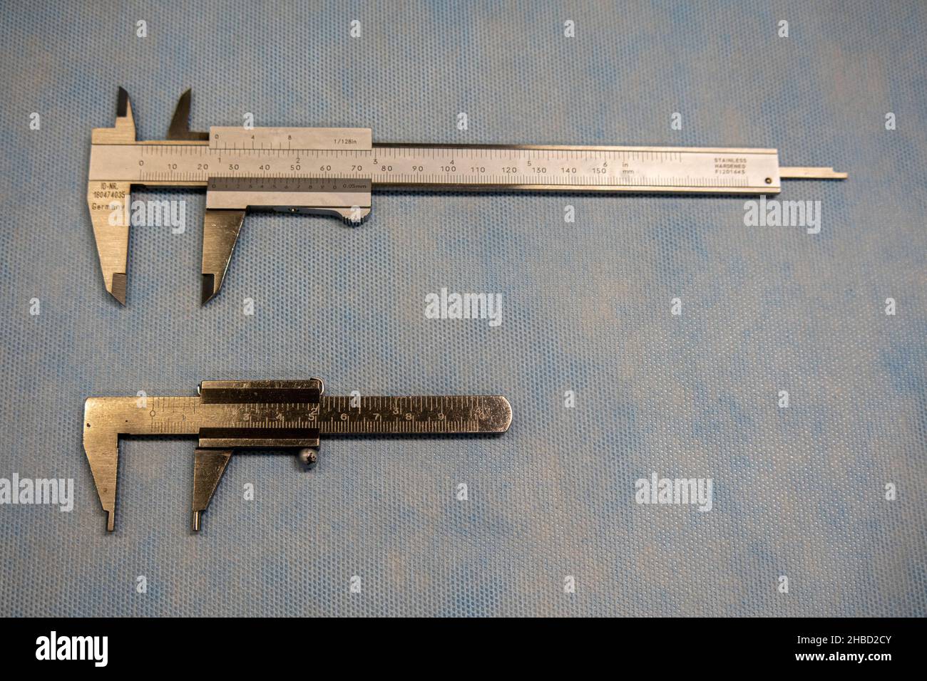 two calipers of different sizes lie next to each other Stock Photo - Alamy