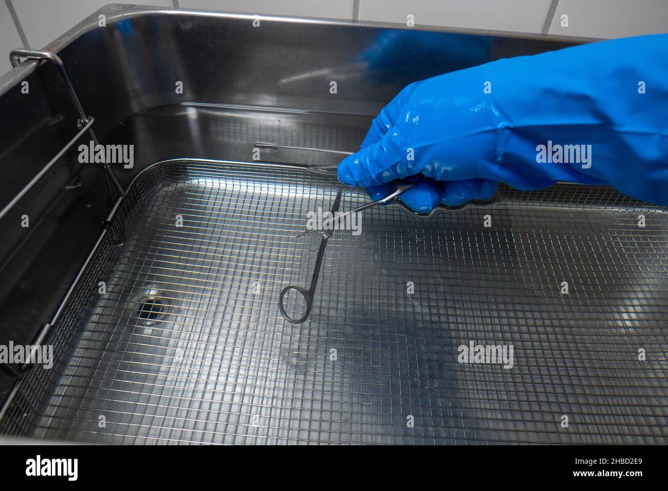 a dirty instrument is placed in an ultrasonic basin Stock Photo - Alamy