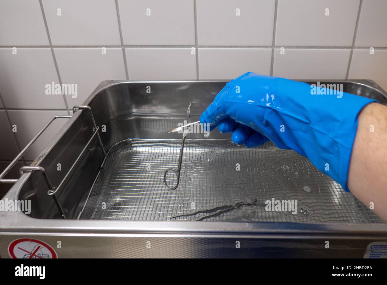 a dirty instrument is placed in an ultrasonic basin Stock Photo - Alamy