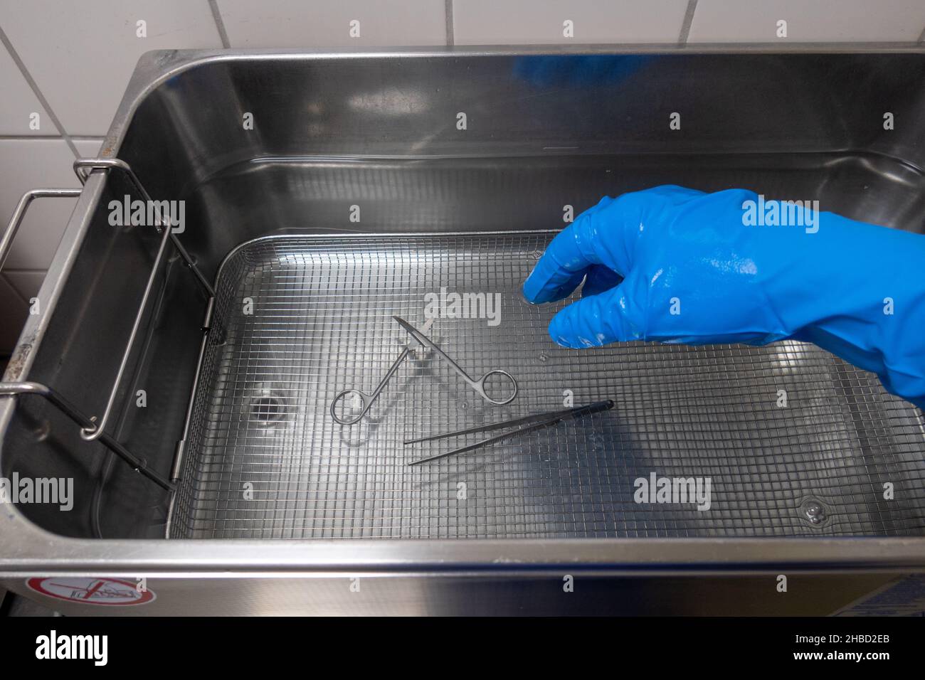 a dirty instrument is placed in an ultrasonic basin Stock Photo - Alamy