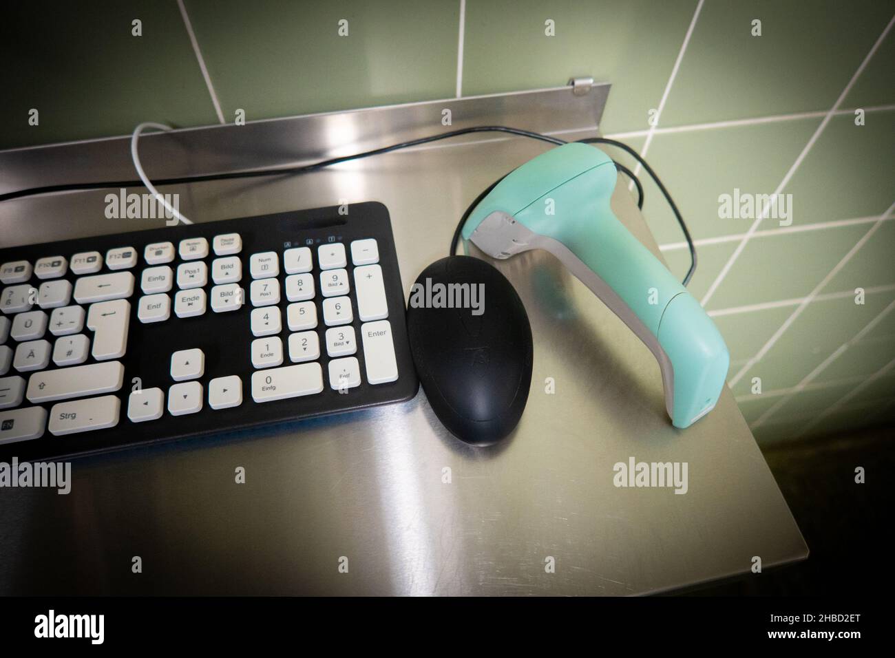 next to one black computer keyboard is a green barcode scanner Stock ...