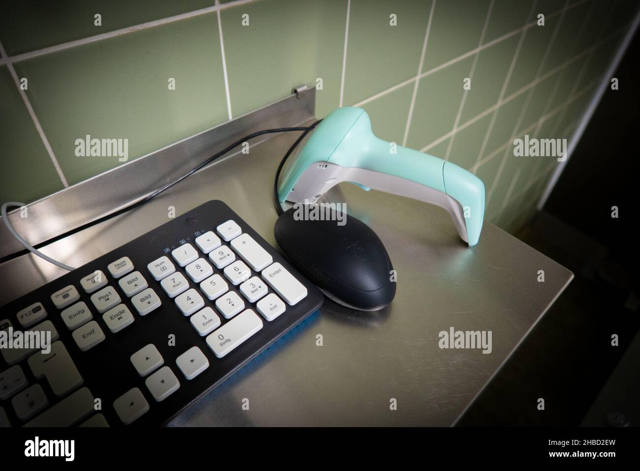next to one black computer keyboard is a green barcode scanner Stock ...