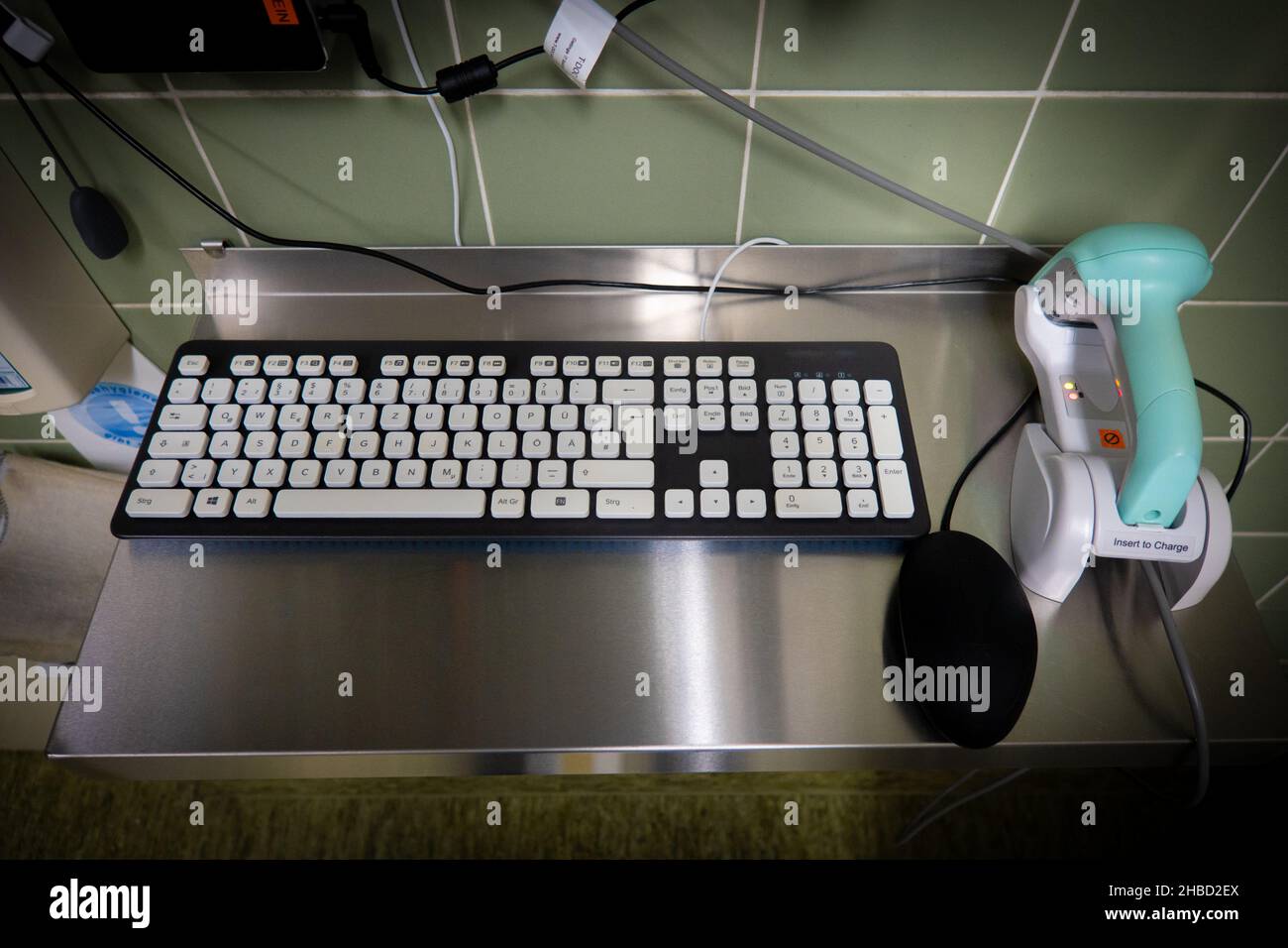 next to one black computer keyboard is a green barcode scanner Stock ...